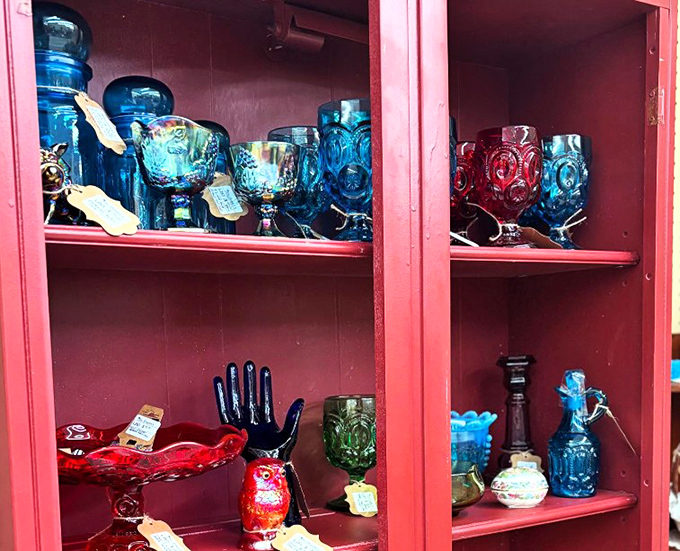 Behind these rosy cabinet doors, cobalt blue glassware catches light like liquid sapphires. Depression glass that's anything but depressing.