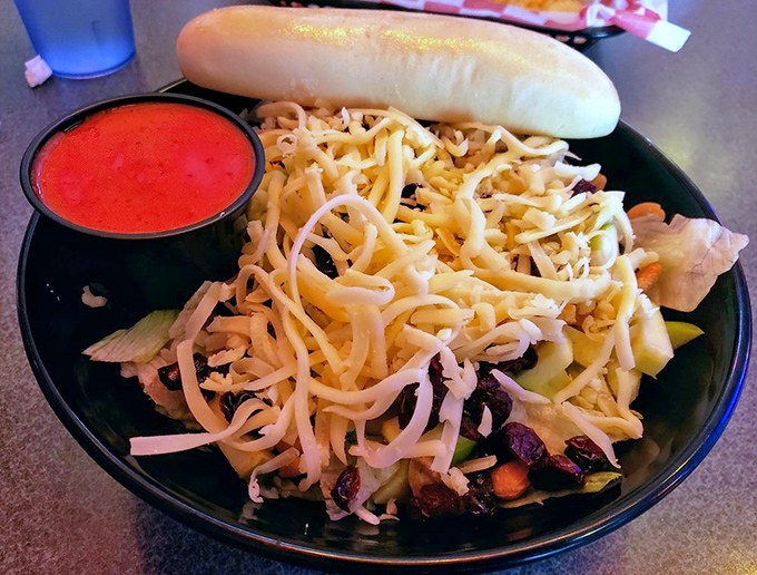 This salad doesn't just have toppings&mdash;it has architecture. A breadstick bridge spans a colorful landscape of vegetables, cheese, and what appears to be the kitchen sink, all in perfect harmony. 