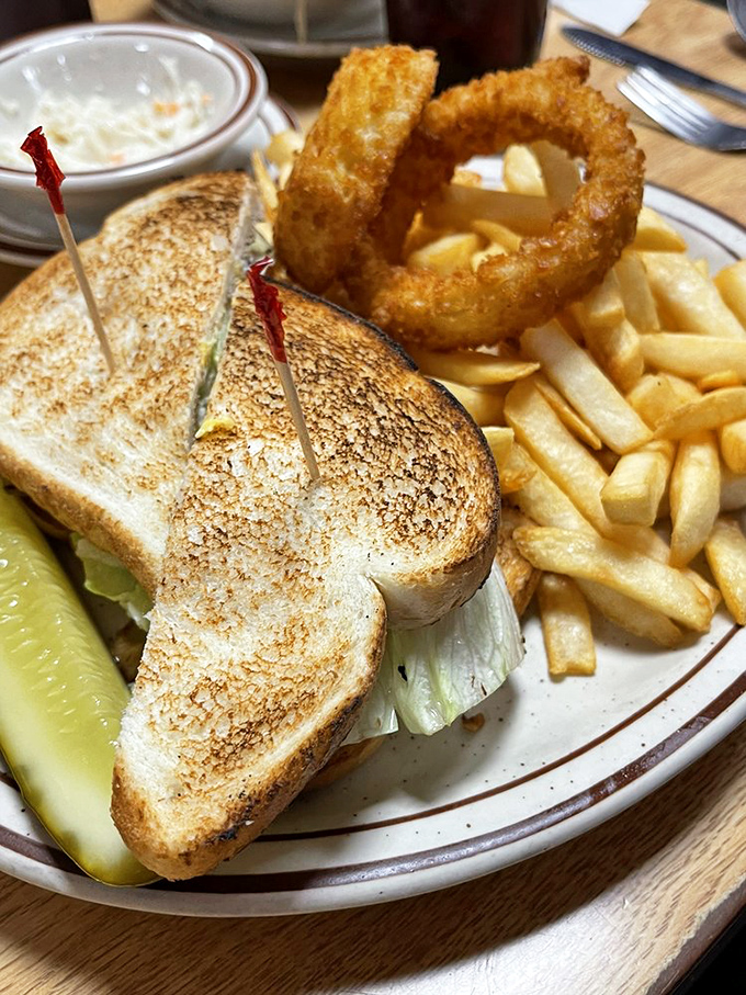 A perfectly grilled sandwich with golden toast, served with fries and an onion ring&mdash;the lunch special that never goes out of style.