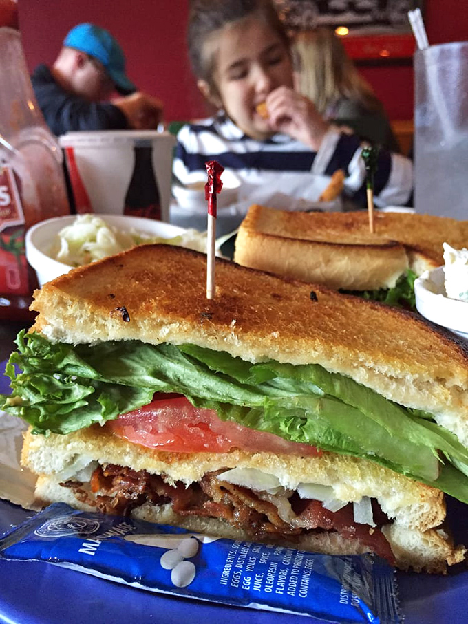 A sandwich stacked so high with fresh ingredients it needs those toothpicks as structural support beams.