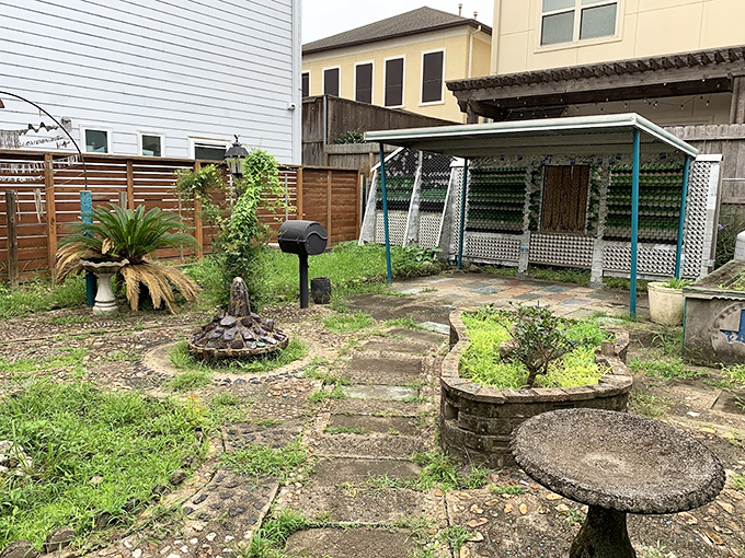 The backyard continues the theme with whimsical garden elements and pathways that turn even a casual stroll into an artistic experience.