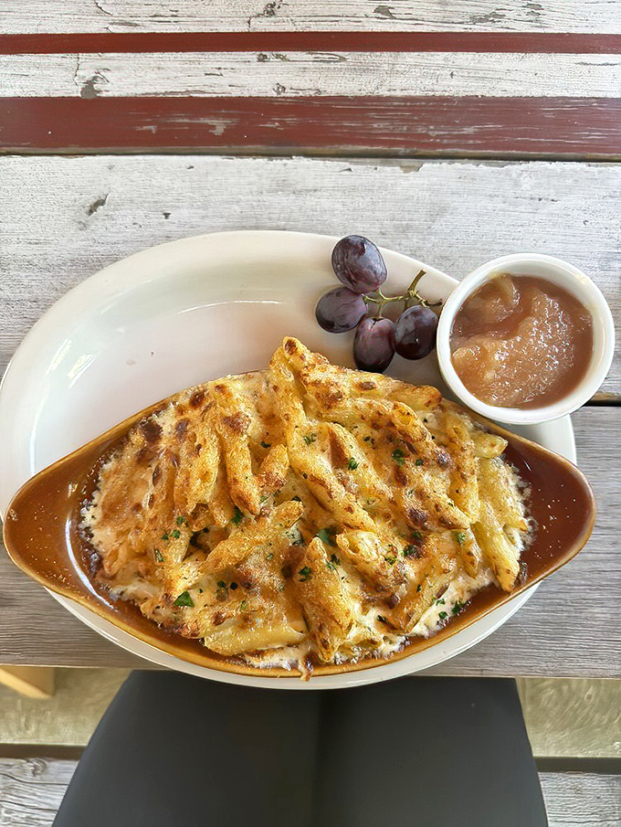 Baked mac and cheese that's achieved the perfect cheese-pull potential. Served with grapes as if to say, "See? There's fruit. It's practically a health food."