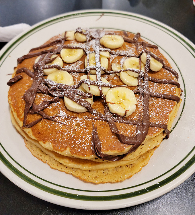 Pancakes stacked high, drizzled with chocolate, and topped with bananas &ndash; breakfast that doesn't pretend to be anything but delicious indulgence. 