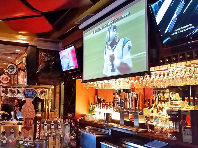 A well-stocked bar where sports fans and cocktail enthusiasts find common ground. Those hanging glasses promise good times are just a pour away.