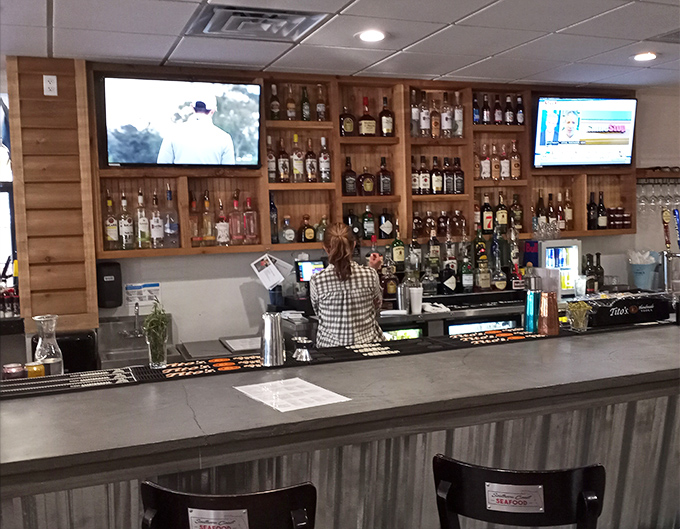 Behind the bar, bottles stand at attention like soldiers guarding the secret to perfect cocktail pairings.