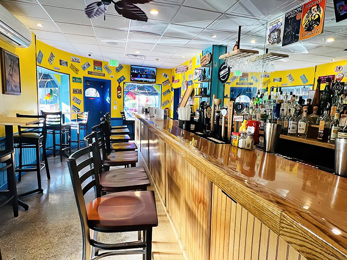 Bar seating with a view of the action. Those yellow walls plastered with memorabilia tell stories that pair perfectly with whatever's in your glass.