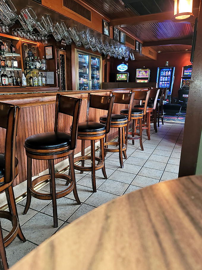 Bar stools await the next round of thirsty patrons. Each worn wooden seat holds stories of pints past and friendships formed over proper ales.