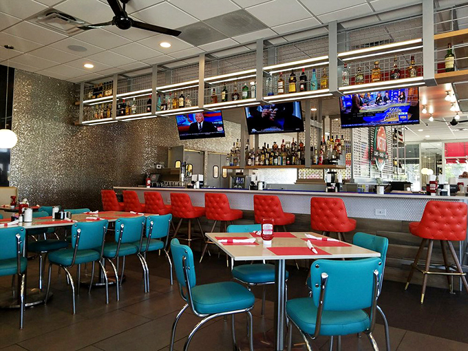 The bar area combines diner charm with evening possibilities—teal chairs invite you to perch while deciding between milkshake or cocktail.