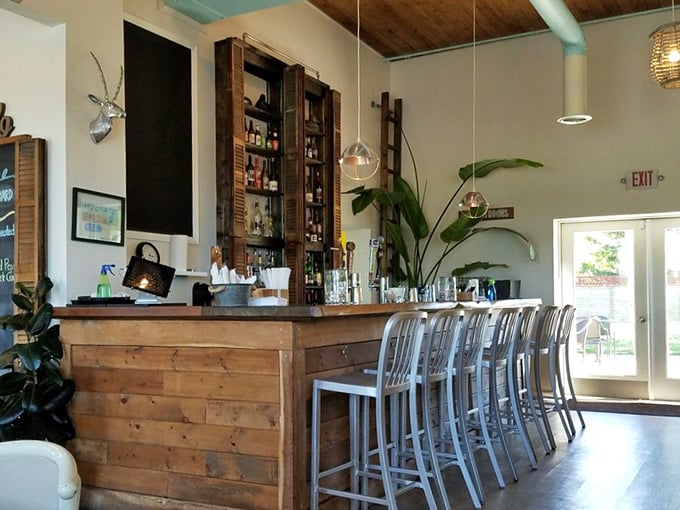 The bar area combines rustic wood with industrial metal, creating a space where both your bourbon-drinking uncle and design-savvy cousin would feel at home.