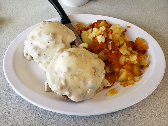 Fluffy biscuits drowning in homemade sausage gravy prove that some comfort foods transcend regional boundaries beautifully.