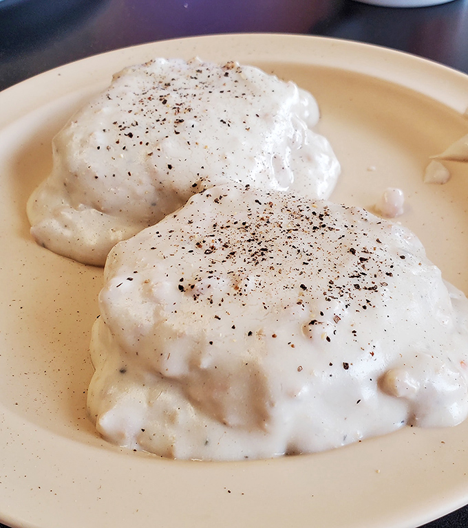 Biscuits and gravy so good they could broker peace treaties &ndash; fluffy pillows drowning in creamy, peppery perfection.