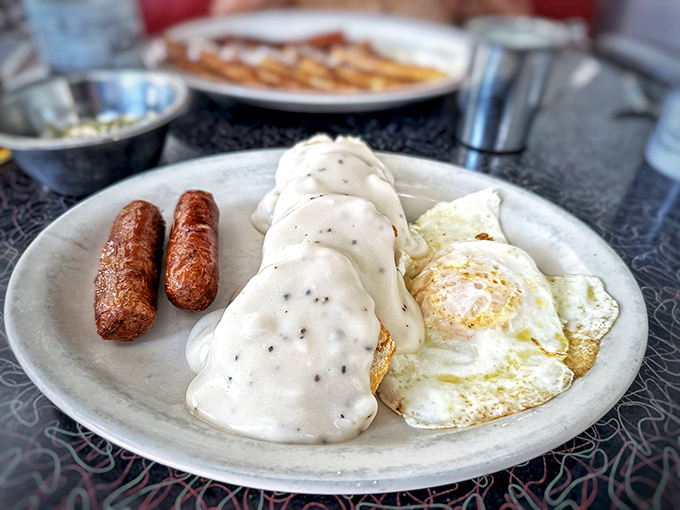 Biscuits and gravy with sunny-side-up eggs and sausage links&mdash;the breakfast that says, "Go ahead, take that nap later. You've earned it."