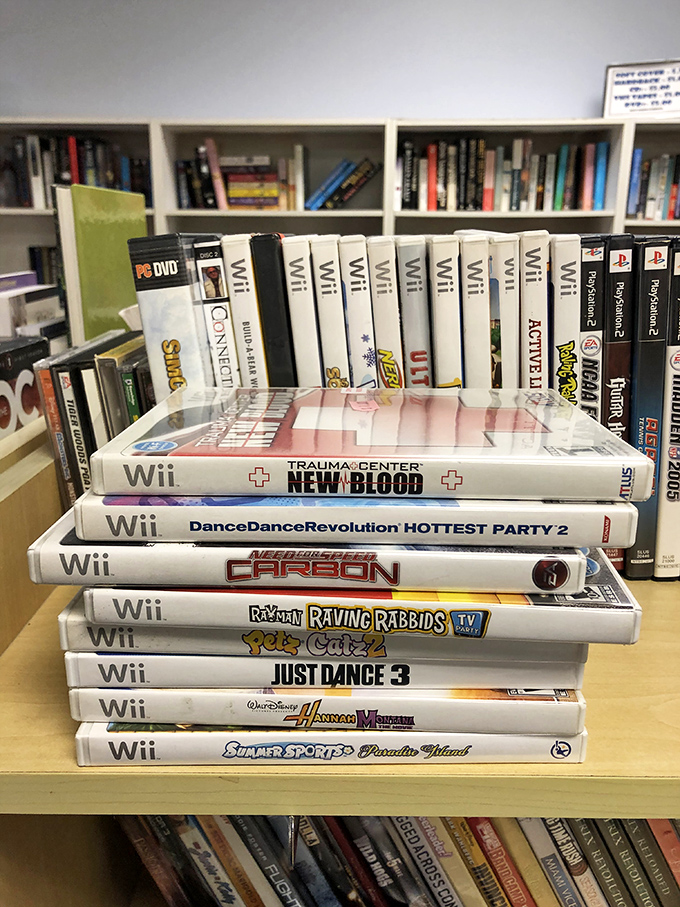 The video game section is a time capsule where forgotten Wii titles wait patiently for their dance revolution to begin again.