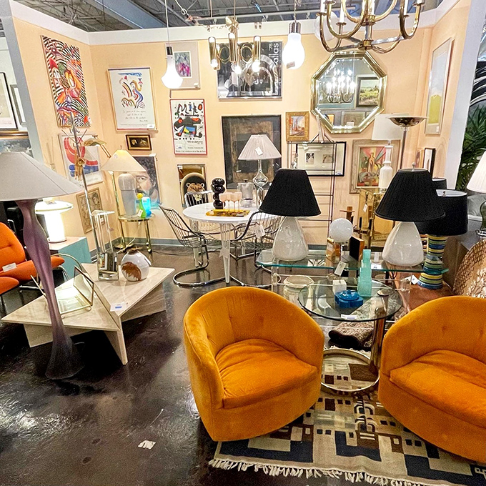 Vibrant orange chairs pop against a gallery wall, proving that mid-century modern and contemporary art can be the best of friends.