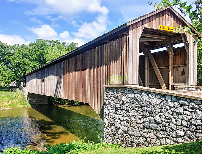 Sunlight plays across the wooden siding, highlighting the craftsmanship that's weathered floods, storms, and the passage of time.