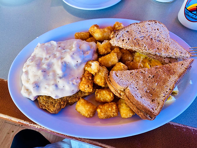 The legendary Bronco Buster plate&mdash;where country-fried goodness meets creamy gravy and crispy tater tots in perfect harmony.