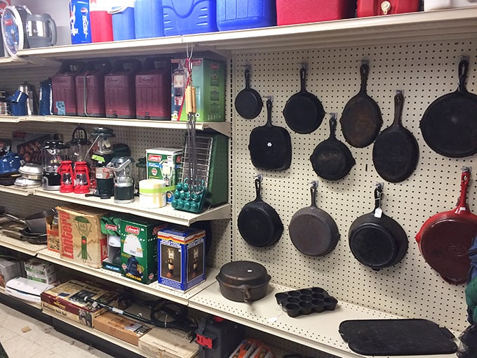 Cast iron cookware hanging like dark culinary medals&mdash;each pan seasoned with decades of family dinners and campfire stories. 