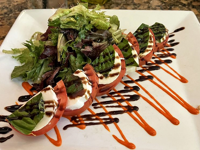 Caprese salad artfully plated with balsamic drizzles that turn simple ingredients into edible poetry on your plate.