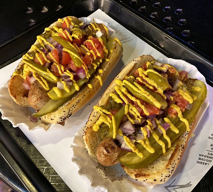 Two Chicago-style dogs, where the neon green relish and yellow mustard create a work of art that tastes even better than it looks.