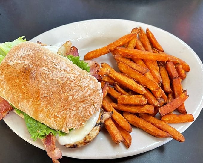 A sandwich that understands the importance of balance&mdash;crispy bacon, fresh veggies, and sweet potato fries for a touch of the unexpected. 