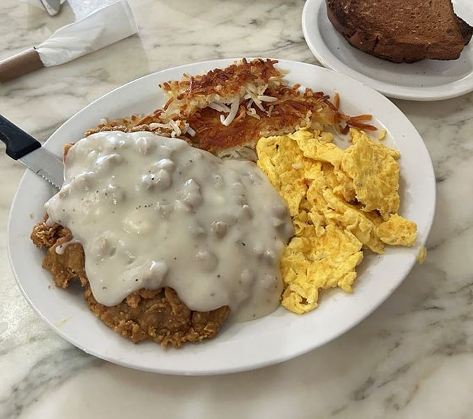 Chicken fried steak with gravy represents America's greatest contribution to breakfast&mdash;a dish that laughs in the face of moderation and whispers, "Live a little."