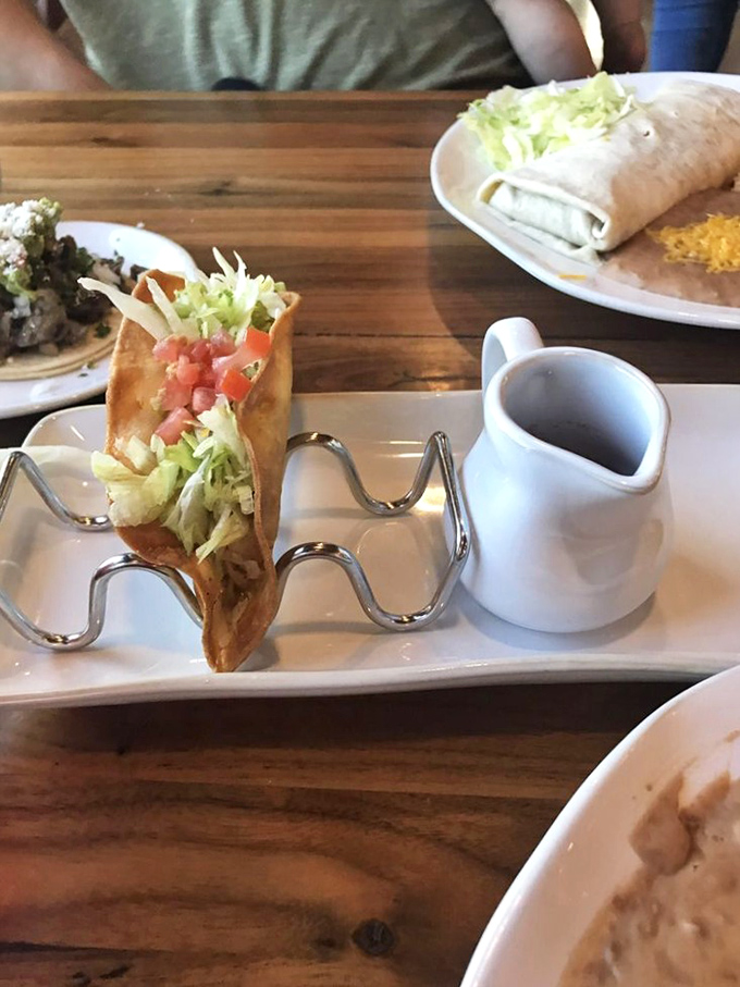 A taco shell becomes edible art when filled with perfectly seasoned chicken and fresh, vibrant toppings galore. 