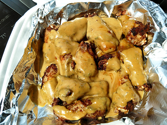 These wings aren't just covered in sauce—they're transformed by it. The foil underneath isn't just packaging, it's a stage for a saucy performance.