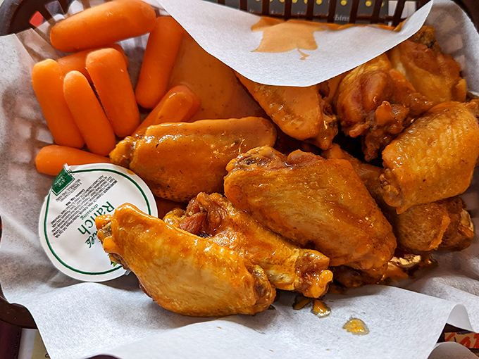 Golden chicken wings arrive crispy and glistening, ready to disappear faster than common sense.