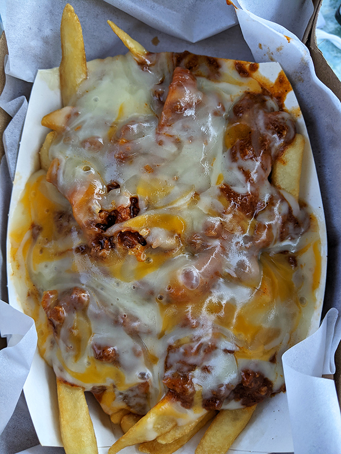 Chili cheese fries that render conversation impossible and make you wonder why anyone would waste time with truffle oil versions costing four times as much.