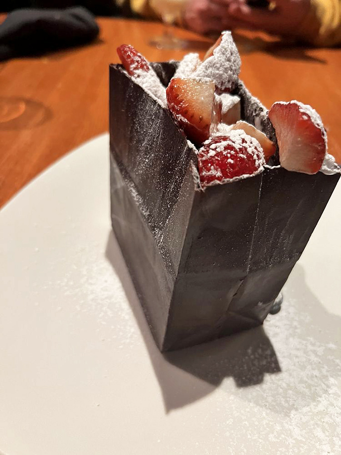 This chocolate dessert "bag" filled with berries isn't just a sweet ending—it's edible architecture that makes you feel like you've discovered buried treasure.