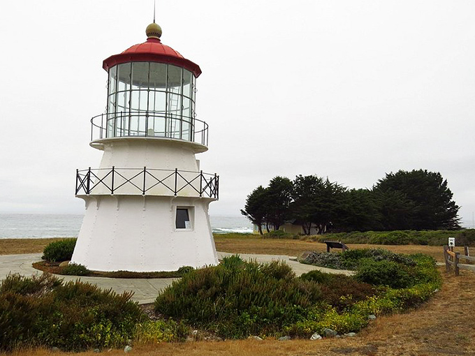 The relocated Cape Mendocino Lighthouse stands sentinel near Black Sands Beach, a historic beacon amid this wild coastal landscape.