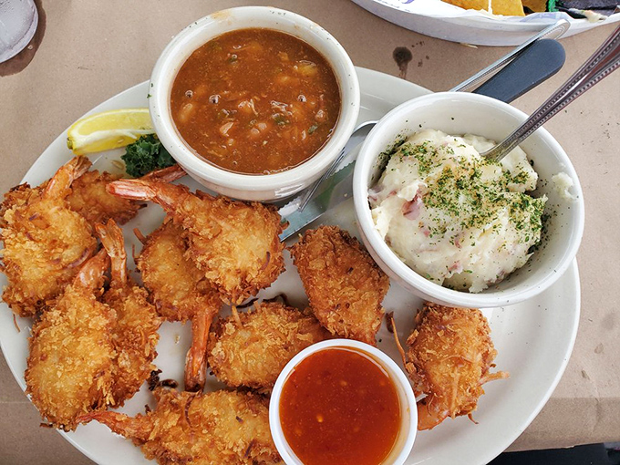 Golden coconut shrimp that crunch like autumn leaves, served with sides that complement rather than compete with the star attraction.