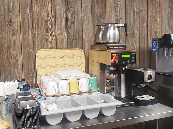 Coffee station ready for the morning rush&mdash;where mugs wait patiently for their daily purpose of delivering liquid motivation to Shelbyville's early risers. 