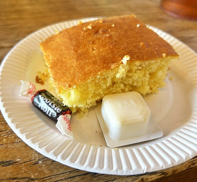 Cornbread so moist and golden it deserves its own spotlight. The Tootsie Roll and butter pat are just bonus points in this carb paradise.