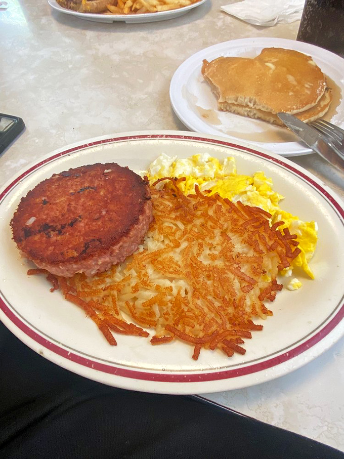 The breakfast of champions who don't care about cholesterol&mdash;crispy hash browns, scrambled eggs, and a ham steak that means business.