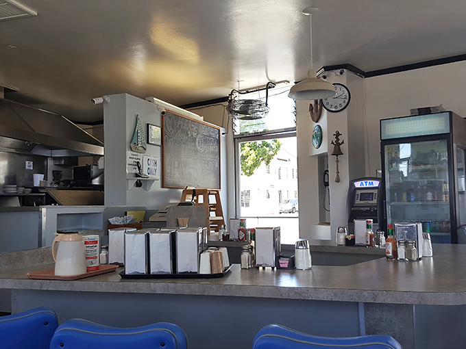 Classic diner efficiency on display&mdash;napkin dispensers, sugar caddies, and menus all within arm's reach while you contemplate your next coffee refill.
