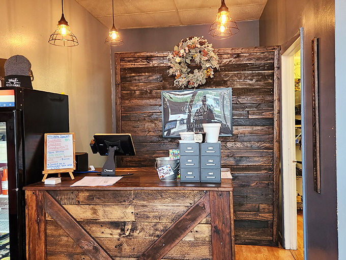 The rustic wooden counter and reception area feels like walking into a modern farmhouse where smoke-infused magic happens daily.