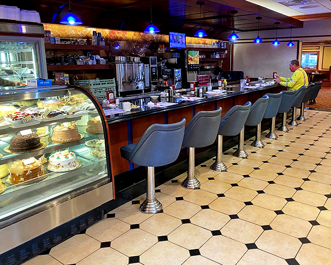 Classic diner counter seating invites solo diners and couples to enjoy front-row kitchen entertainment.