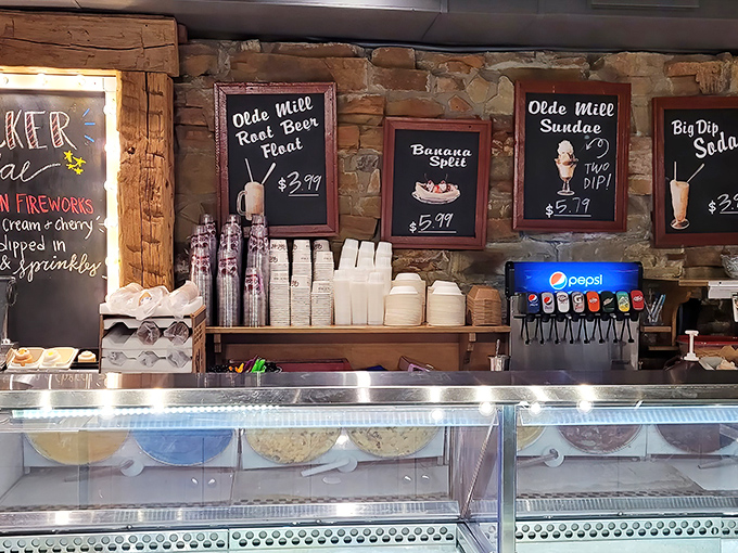 The service counter promises cold treasures behind glass. Those menu boards are basically love letters written in chalk.
