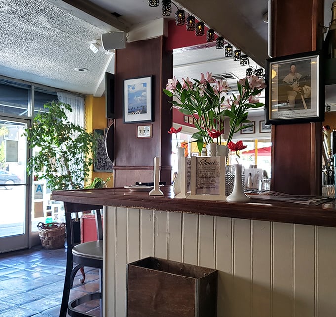 Fresh flowers and warm wood tones welcome you to the counter, where pizza dreams begin their journey to delicious reality.
