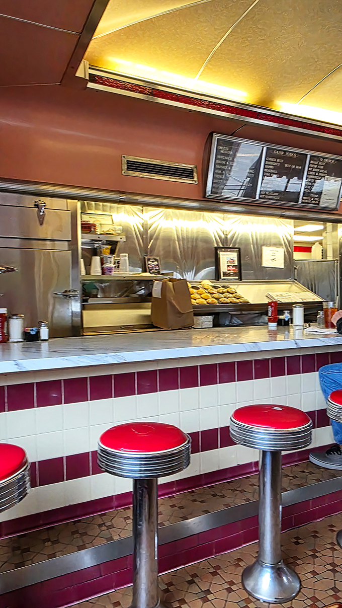 The counter—where solo diners find community, regulars establish territory, and everyone has a front-row seat to the short-order symphony.