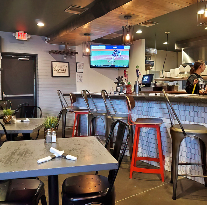 Bar seating offers front-row tickets to the barbecue show&mdash;where sports on TV and smoked meats on plates create the perfect American pairing.