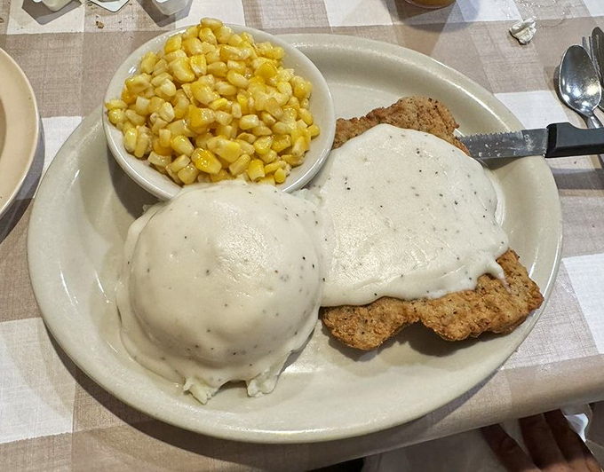 Country fried steak swimming in pepper-flecked gravy with a side of buttery corn&mdash;cardiac concern has never tasted so heavenly.