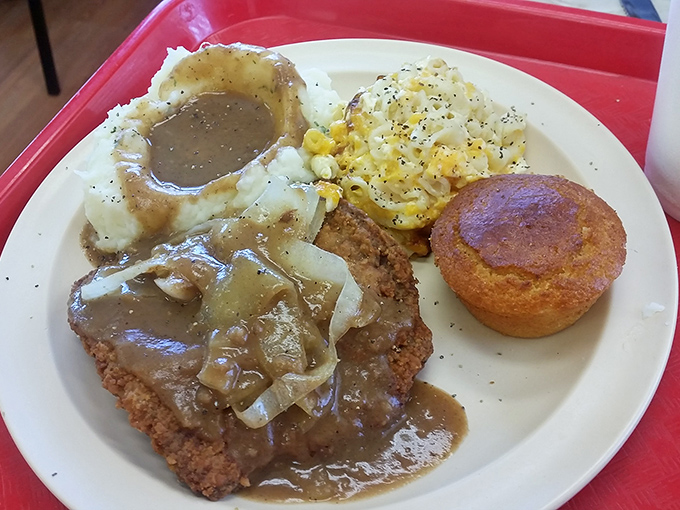 Country fried steak bathed in gravy with a cornbread sidekick - a plate that renders conversation unnecessary for at least the first three bites.