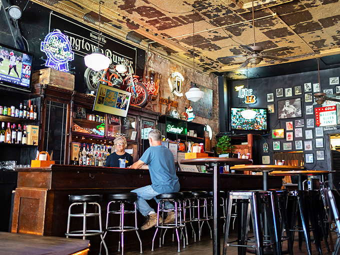 Inside Court Grill, where the ceiling tells stories of its own, locals gather at the bar for drinks, conversation, and no-nonsense hospitality.