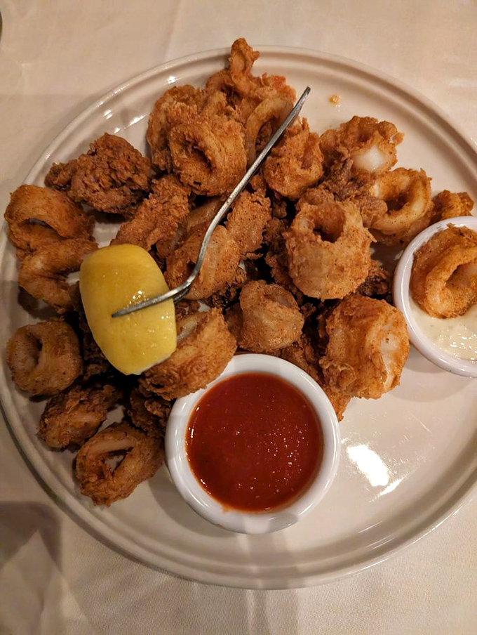 Golden calamari rings arrive like edible jewelry, crispy perfection that proves great steakhouses excel beyond just beef.