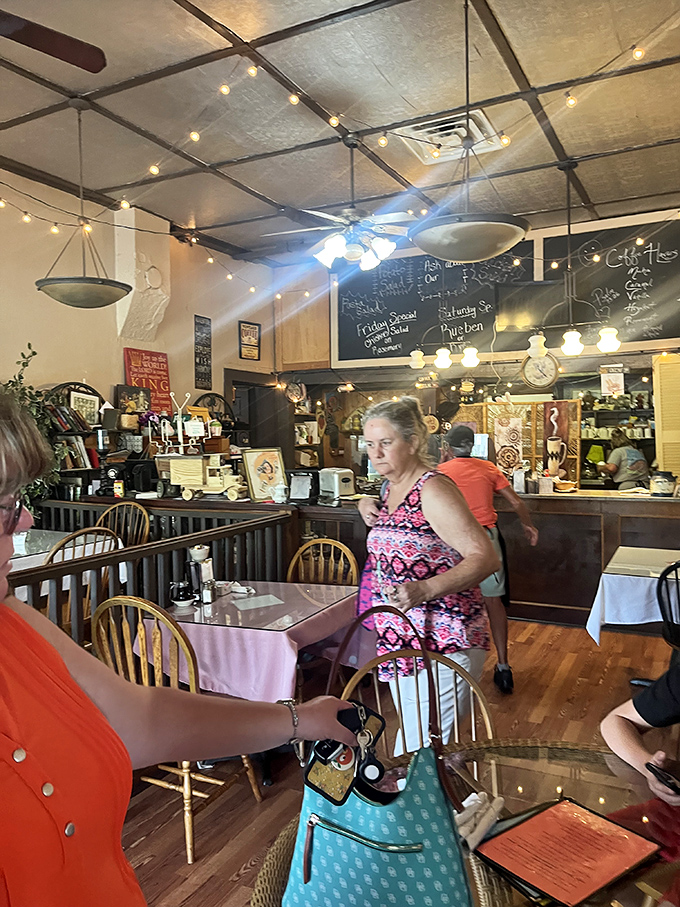 The dining room buzzes with locals and visitors alike. String lights cast a warm glow over conversations that flow as easily as the coffee refills. 