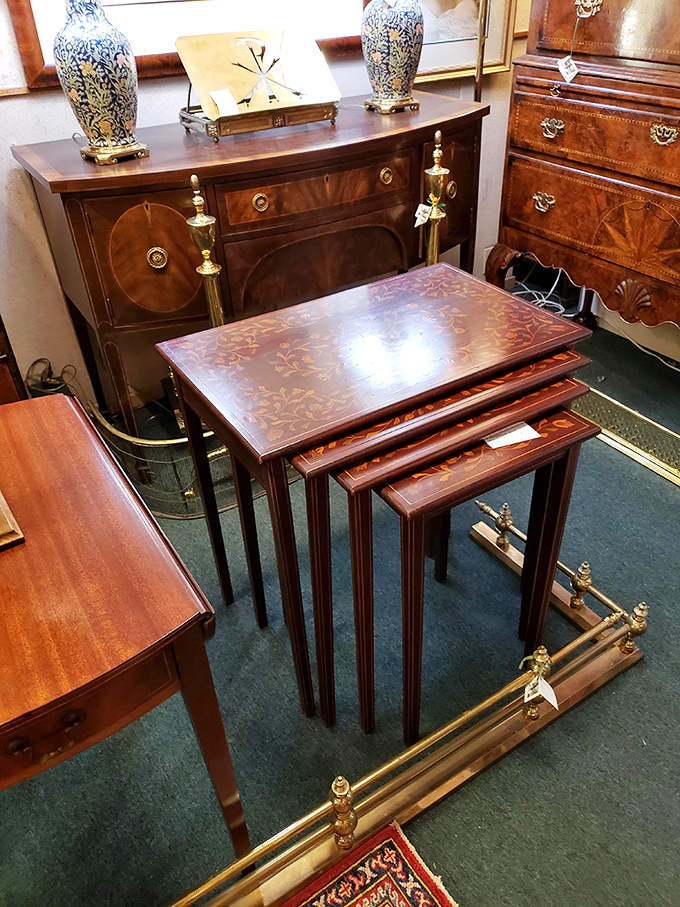Nesting tables that would make Russian dolls jealous. The inlaid marquetry top tells stories in wood while blue-and-white porcelain vases stand guard.
