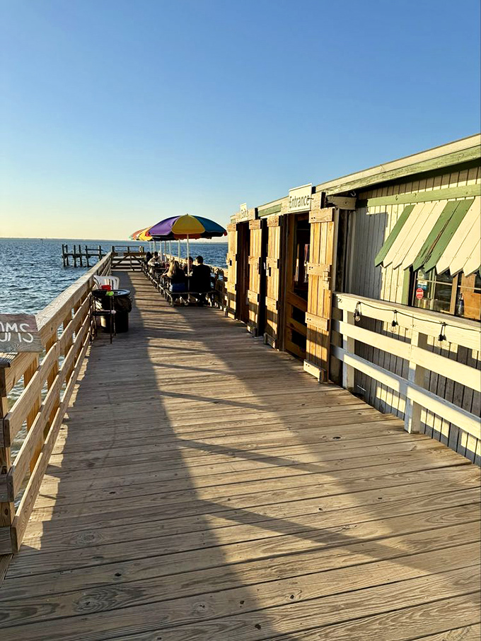 A wooden walkway to seafood nirvana &ndash; where rainbow umbrellas and harbor views set the stage for memorable meals.