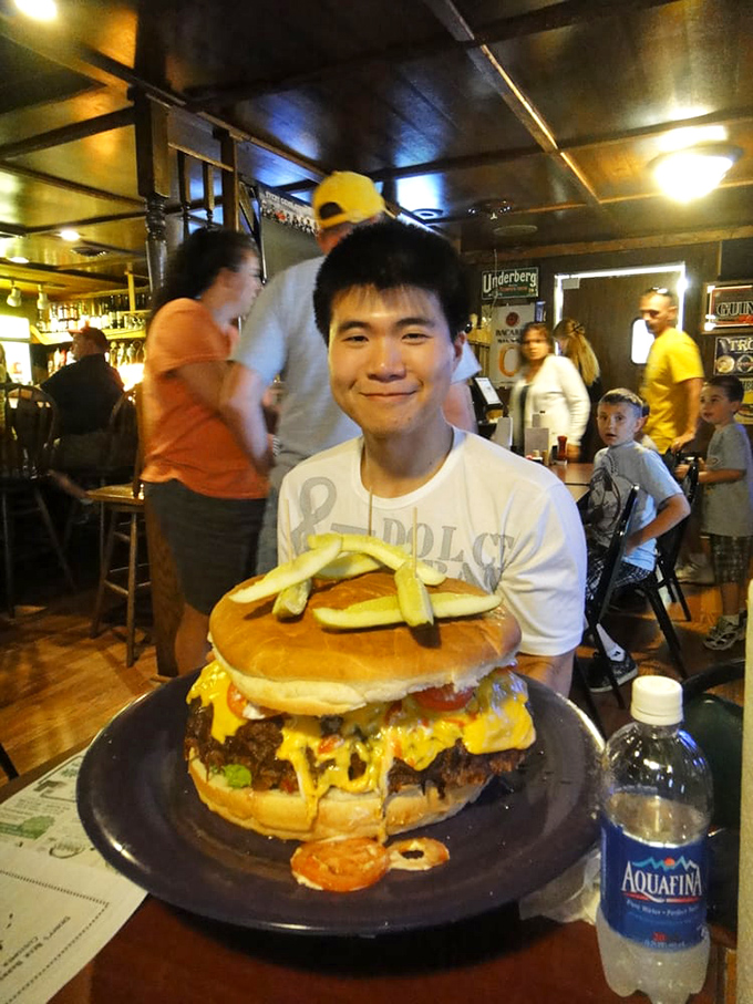 That's not a burger&mdash;it's a skyscraper with cheese. The look of determination says it all: challenge accepted!